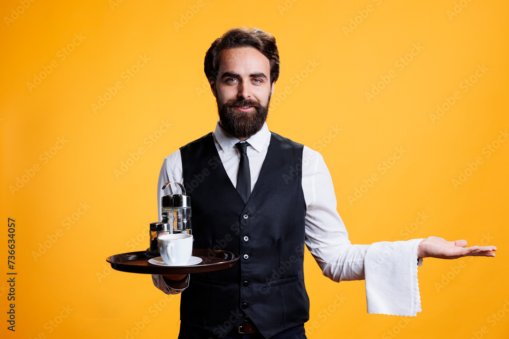 Gracious waiter creating marketing ad in studio, posing with tray in ...