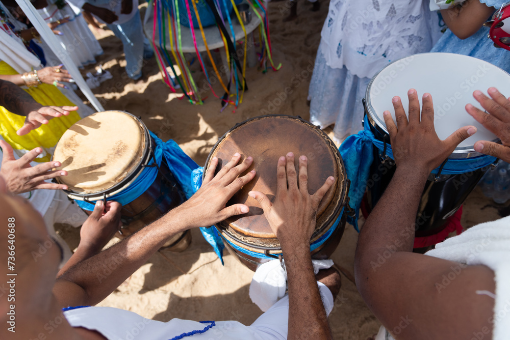 People are seen playing percussion instruments during a party for ...