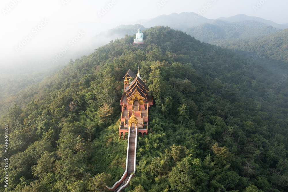 Aerial view of Wat Prathat Doi Prachan and Great Buddha at Doi Phra Chan is a towering bronze ...