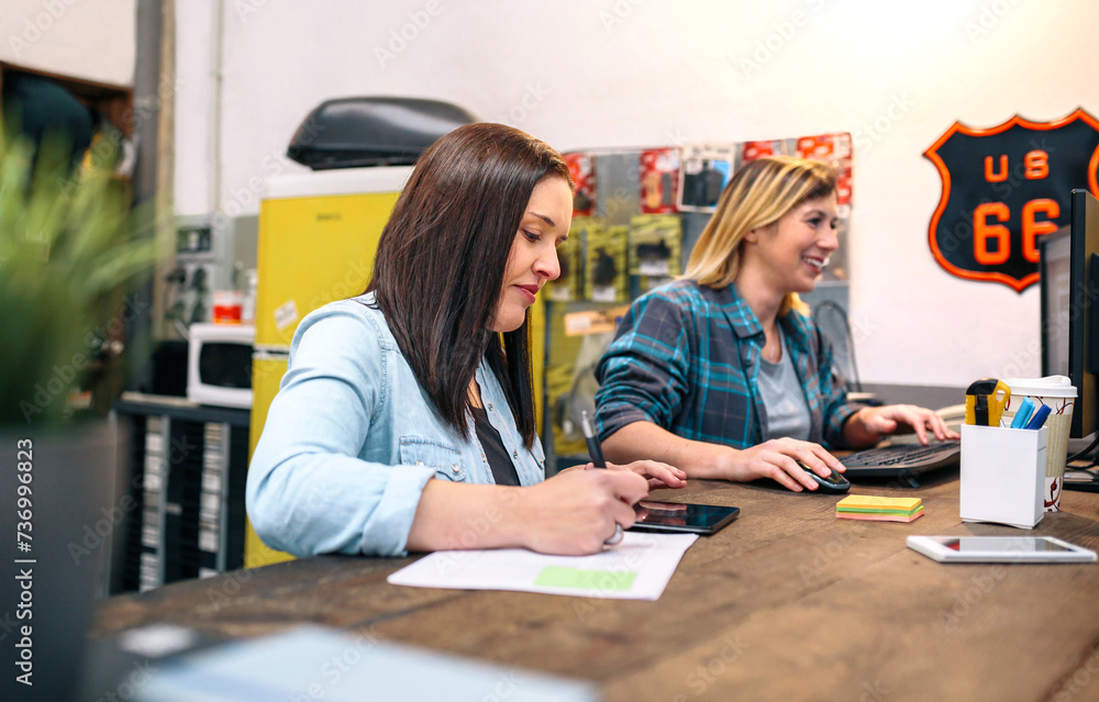 Cheerful women entrepreneur working selling on line in a small business ...