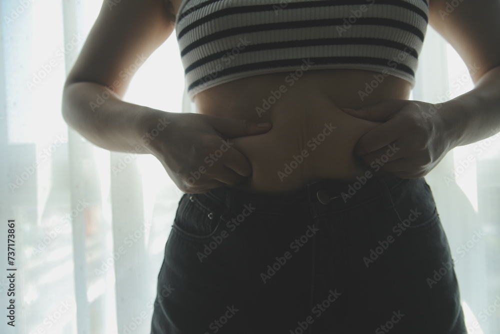 Women body fat belly. Obese woman hand holding excessive belly fat ...