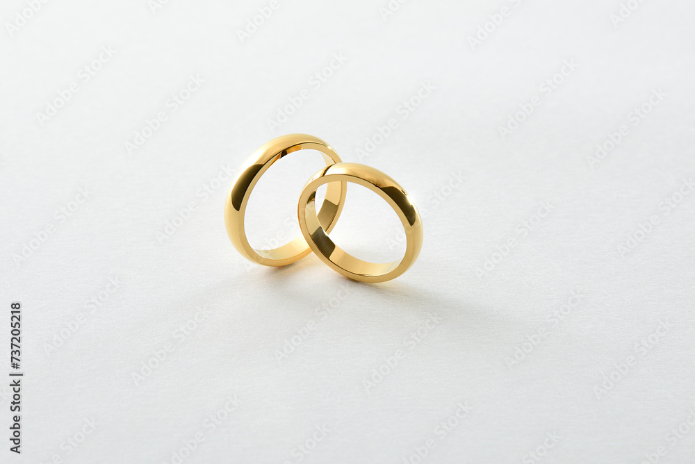 Engagement gold rings standing perpendicular to each other isolated ...