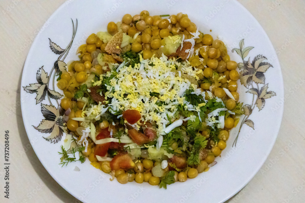 Spicy Chotpoti with chaat masala, chana, chola, chili, and egg served ...