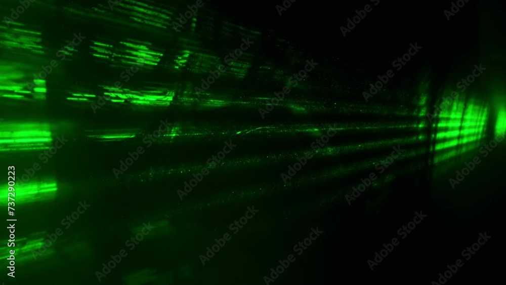 Green laser beams lighting in smoke on a black background. Laser disco ...