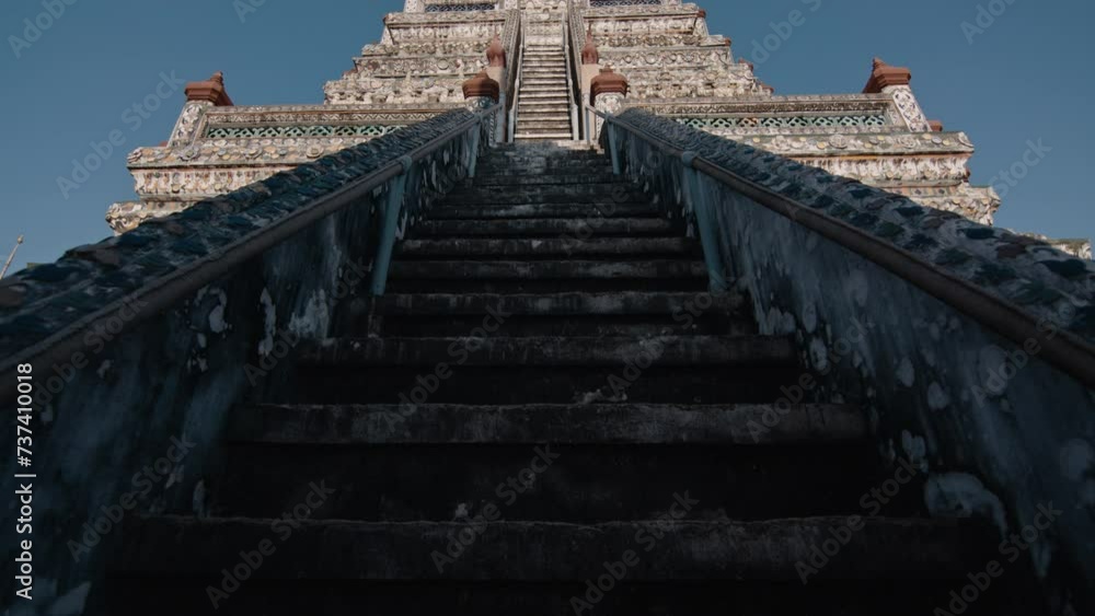 Wat Arun temple in Bangkok, stairs going up, majestic ancient Buddhist ...