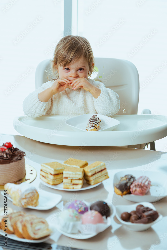 Cute toddler eats cake with chocolate, harm from sugar to the health of ...