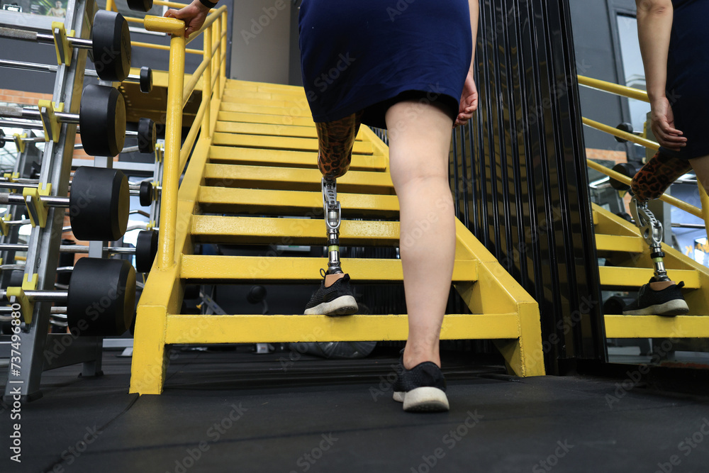 Disabled athletes practice exercise in the gym. Practice going up and ...
