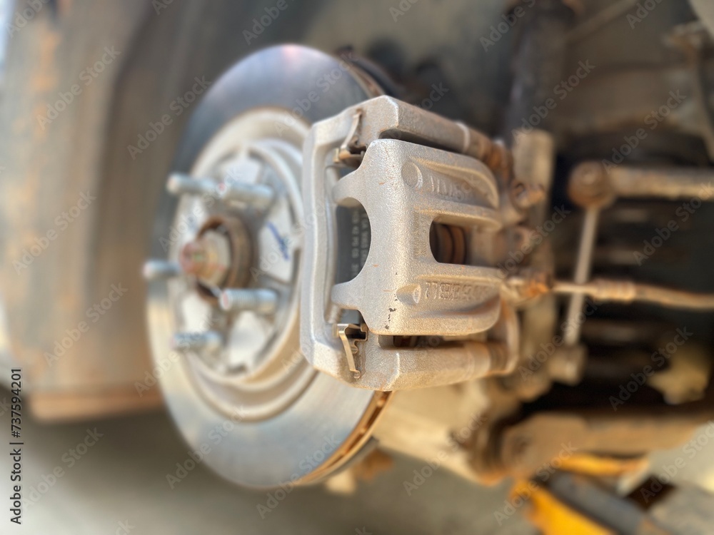 An electric vehicle inspection involves checking brake pads and disc ...