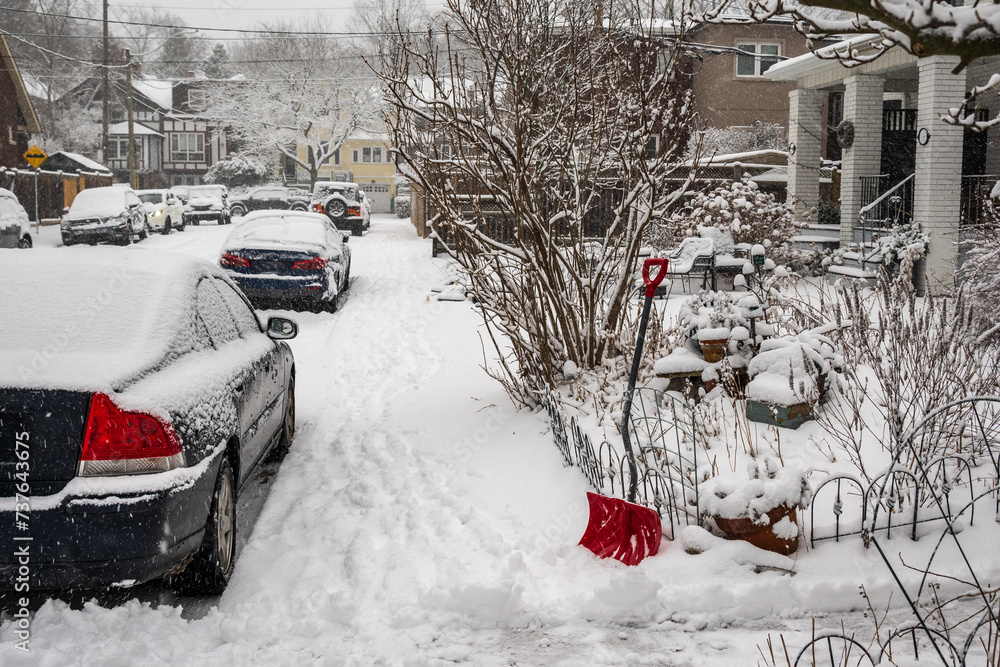 Snow on a recently cleared walkway and stairs of an older residential ...