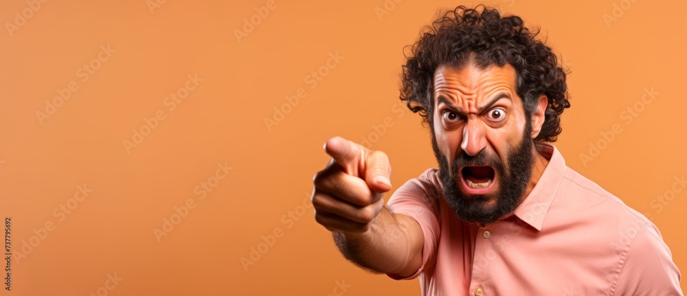 Middle Eastern man, her features contorted in aggression, pointing ...