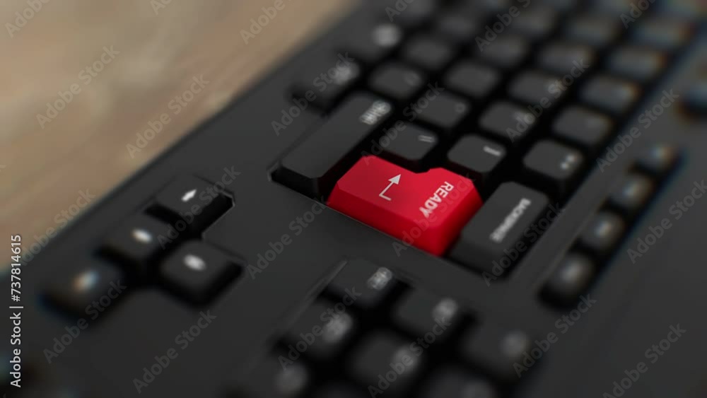 Ready button on keyboard turned upside down. A finger presses Enter ...