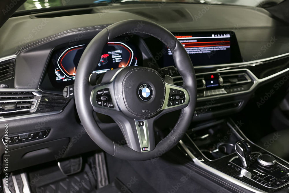BMW X5 steering wheel and dashboard. Black leather interior of the SUV ...
