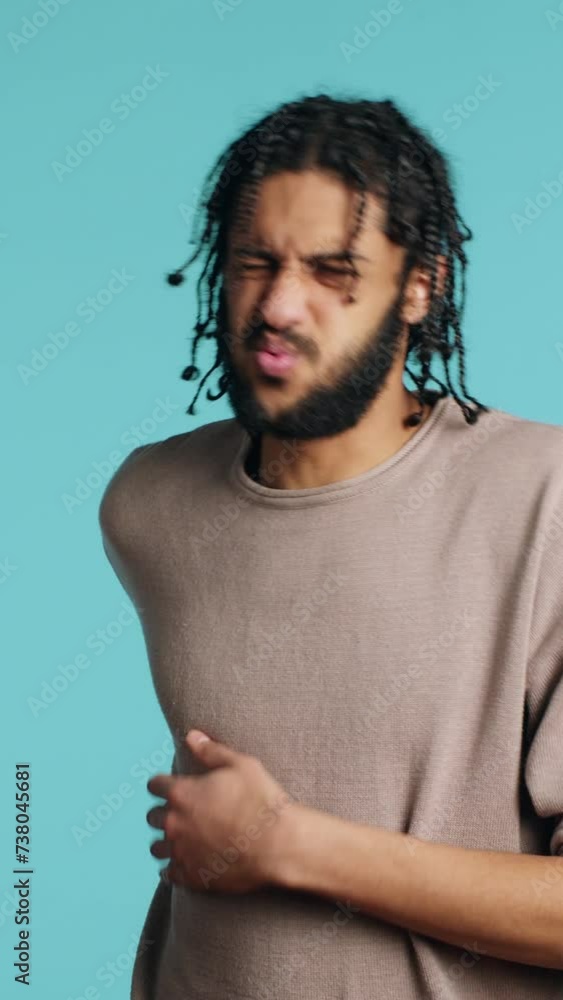 Vertical video Hurt african american man screaming from pain, suffering ...