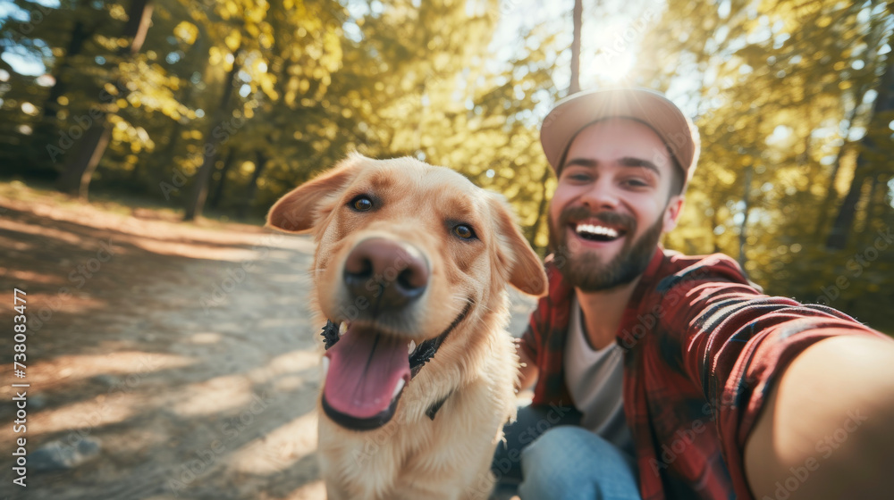 Selfie picture of a young happy man walking his dog in a park , smiling ...