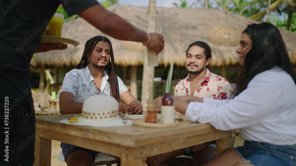 Vidéo Stock Diverse LGBTQ friends enjoy brunch at tropical outdoor cafe ...