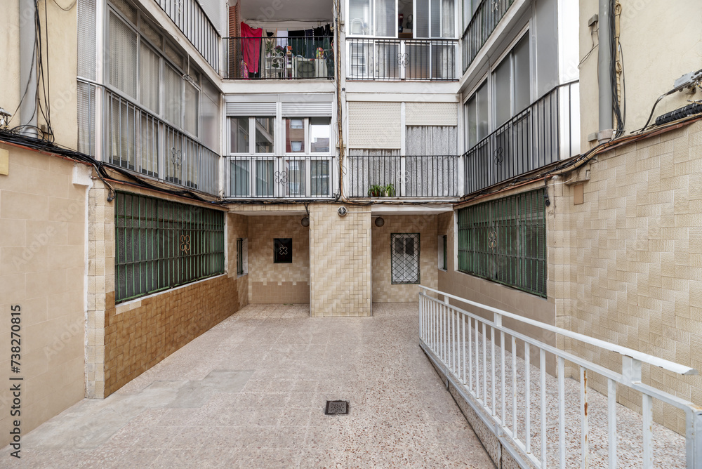 Building facade with balconies and closed aluminum windows of various ...