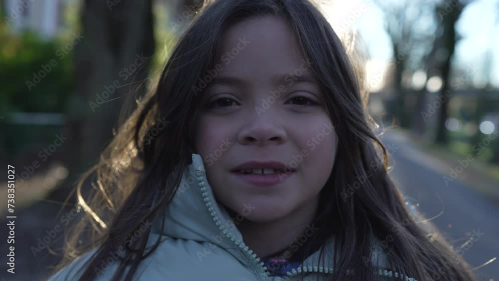 Close-up face of 8 year old female child looking at camera standing ...