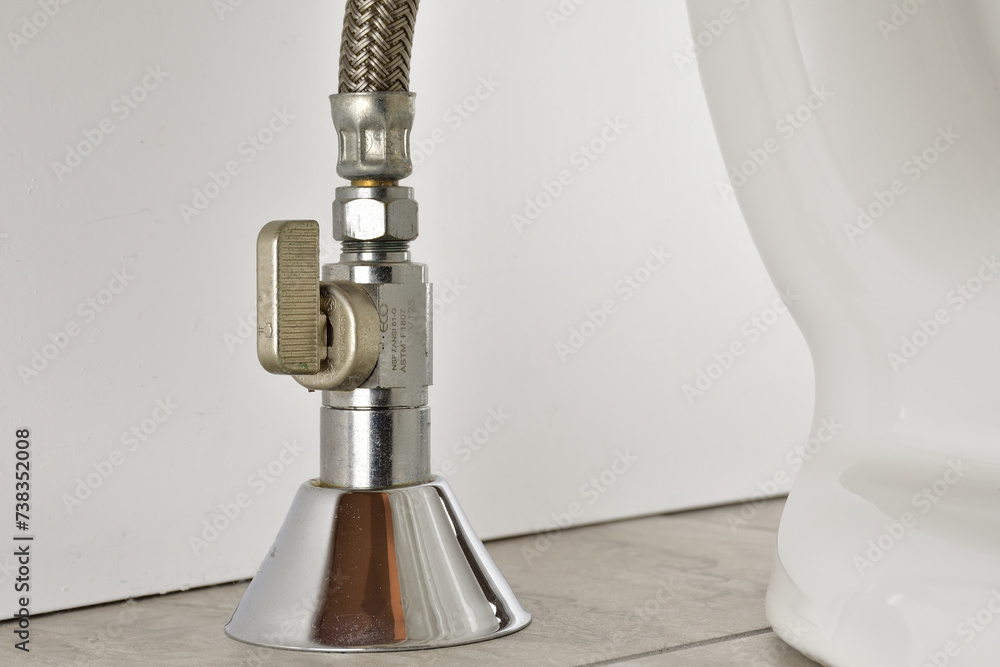 Toilet water feed line. Water valve on toilet inlet with braided hose ...