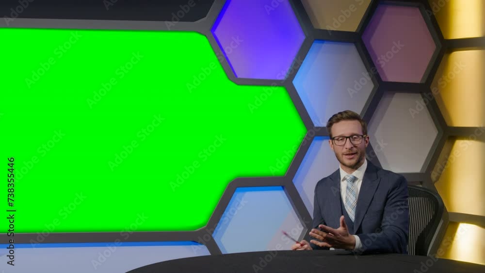 White News Reporter in a dark blue suit is sitting at a table in front ...