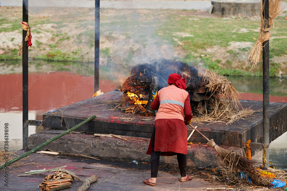 Staff employee of Pashupatinath Temple complex overseeing for funeral ...
