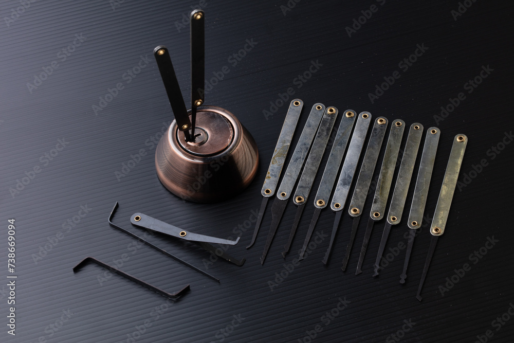 Deadbolt Lock device with lock pick insert to key hole over black ...