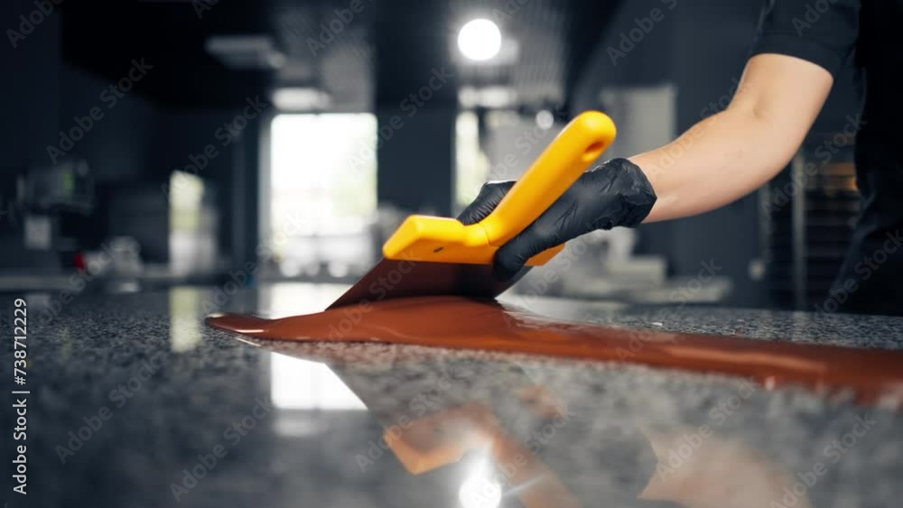 Close-up shot of a pastry chef tempering chocolate before preparing ...