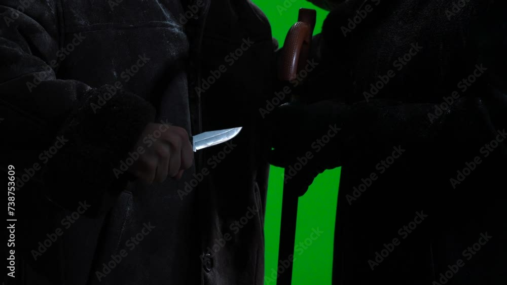 Silhouette of aggressive man standing with knife in hand indoors ...