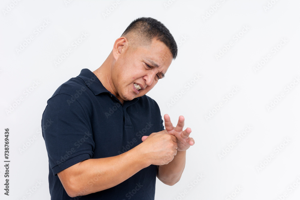 An asian man in his 50s showing pain in thumb, indicative of texting ...
