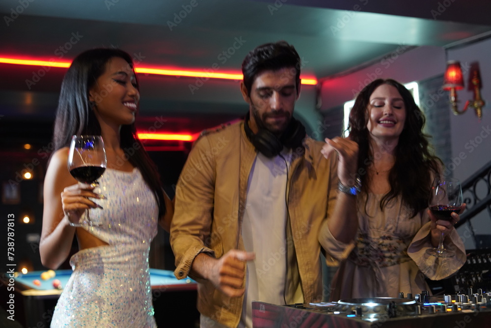 Disc jockey Dj mixing party in bar .Two young Asian and Caucasian ...