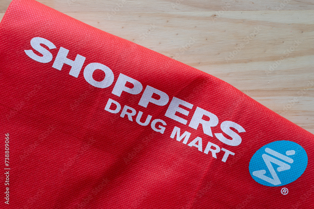 red cloth bag with logo from Shopper Drug Mart, a ubiquitous chain drug ...
