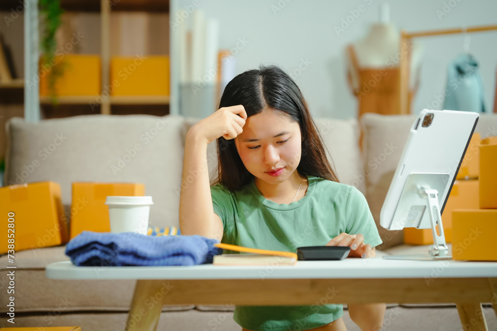 young Asian SME owner of a clothing store faces stress and sadness due ...