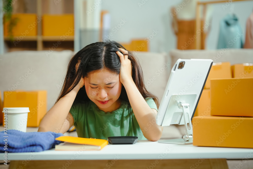 young Asian SME owner of a clothing store faces stress and sadness due ...