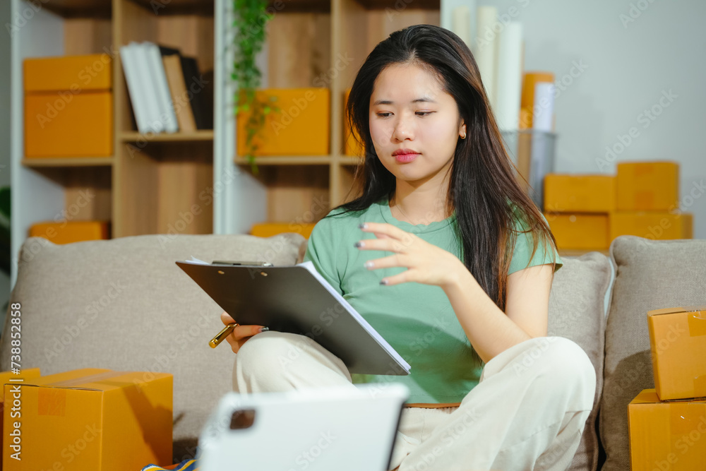 young Asian SME owner of a clothing store faces stress and sadness due ...