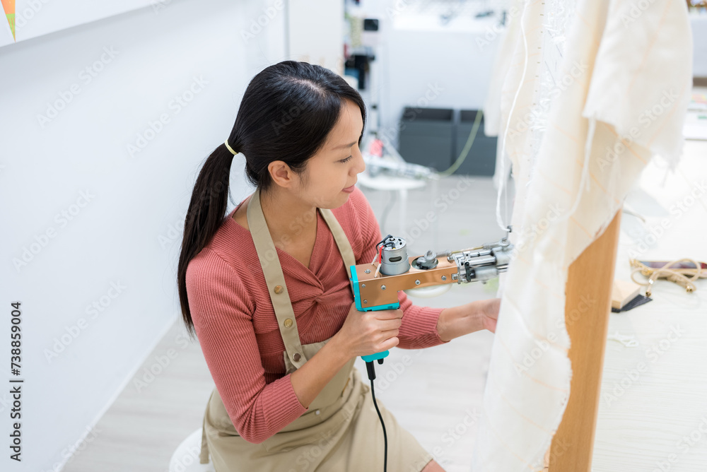 Woman choose the color of thread for making of tufting carpet at studio ...