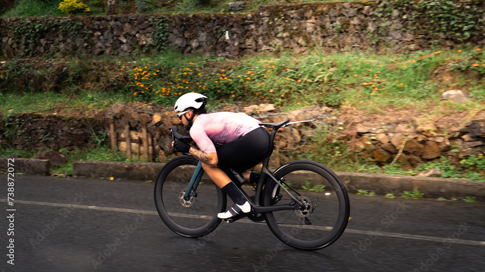 Motivated and determinated cyclist in lying on the bicycle frame in an ...