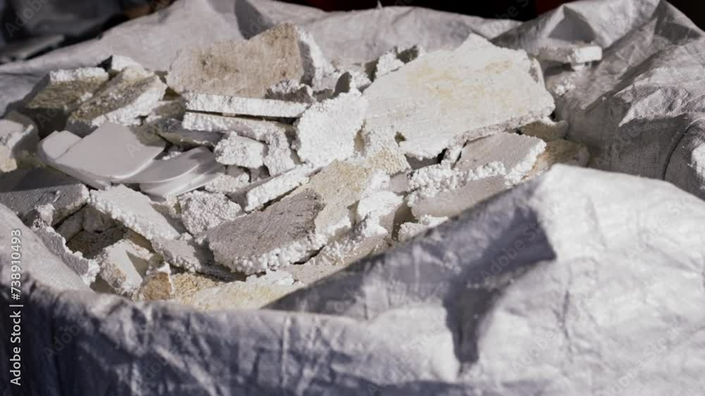 Close-up of a lot of styrofoam lying in a big bag at a waste recycling ...