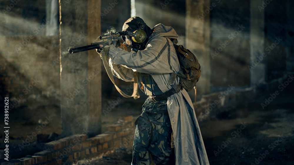 a sniper in a military uniform with a weapon and a gas mask on his face ...
