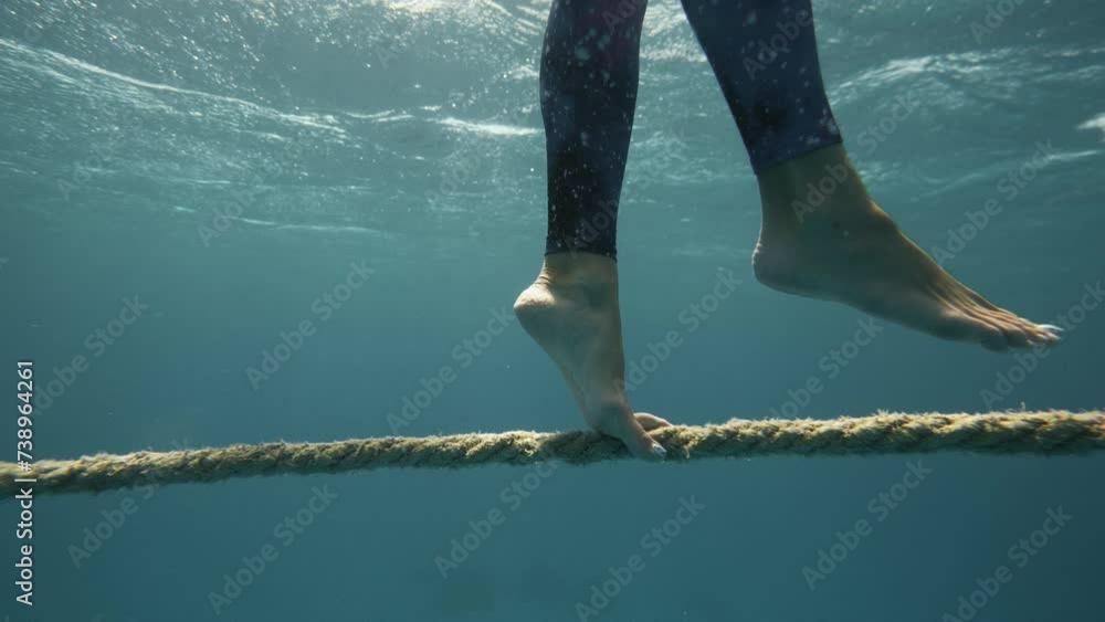 Underwater dream, woman step on tightrope. Female bare feet walk on ...