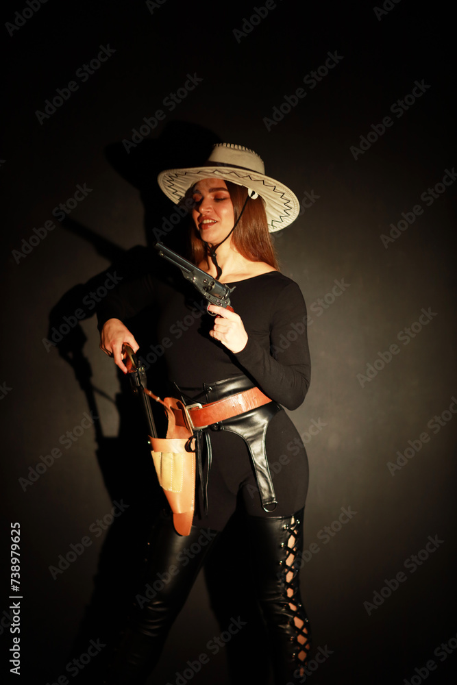 Beautiful young woman in white hat with two old revolvers low key ...