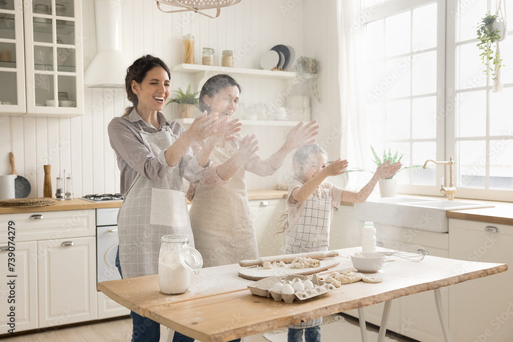 Cheerful preschooler 5s girl, her mother and granny having fun while ...