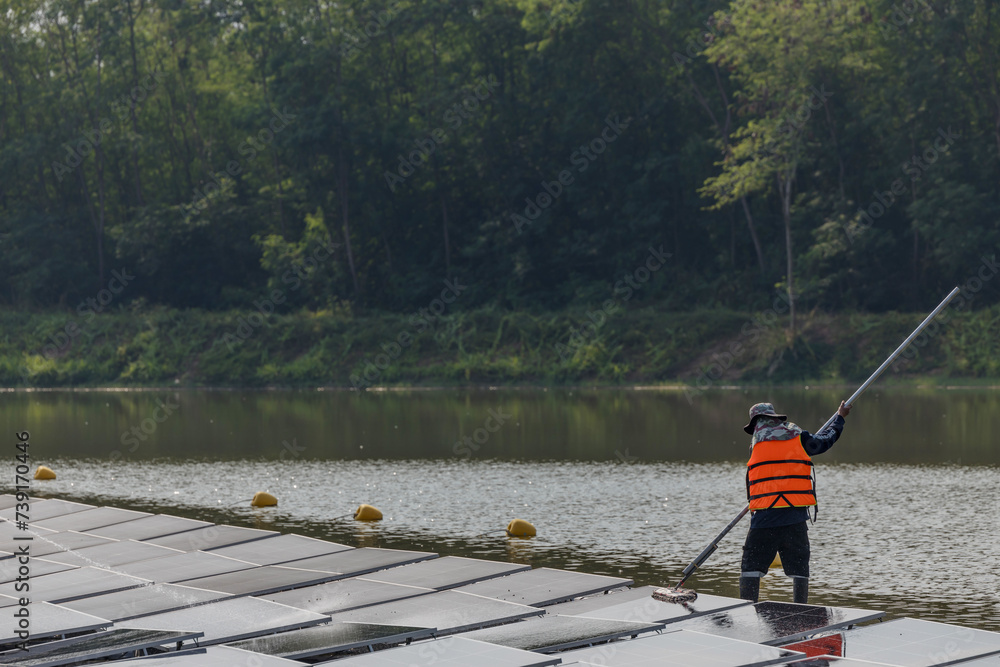 Worker Cleaning floating solar panels or solar cell Platform system on ...