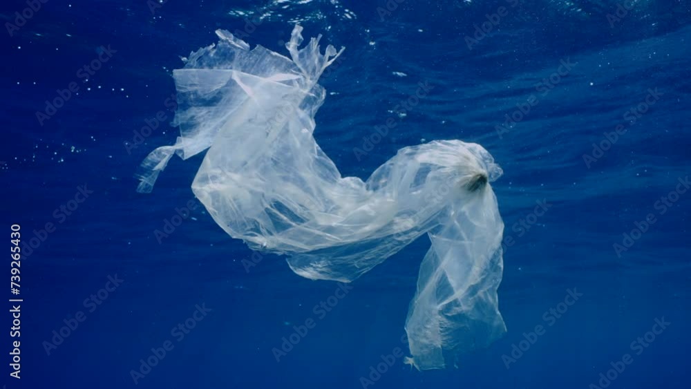 Plastic trash in water, bag floating underwater inside ocean. Slow ...