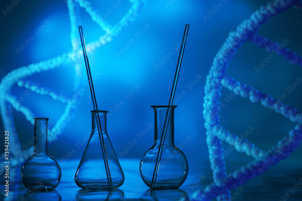 DNA science. Genome chains near test tubes. Glass flasks for genetic ...