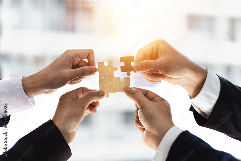 Office workers holding a jigsaw puzzle, teamwork and unity, charity ...