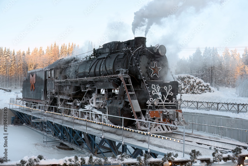 Ruskeala, Karelia, Russia - January 05, 2024. Retro train on a turning ...