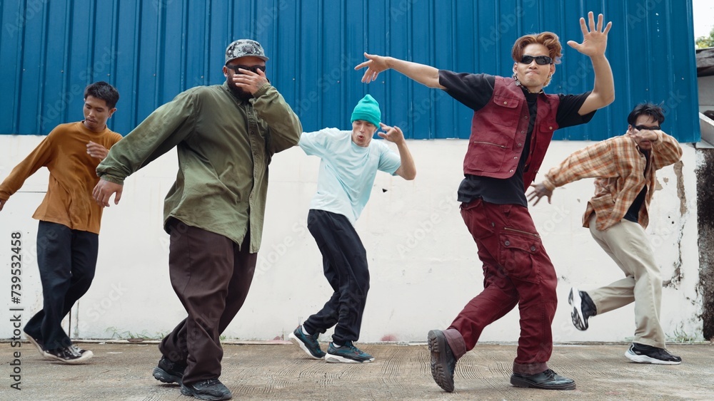 Group of hip hop choreographer dancing street dance together at wall ...