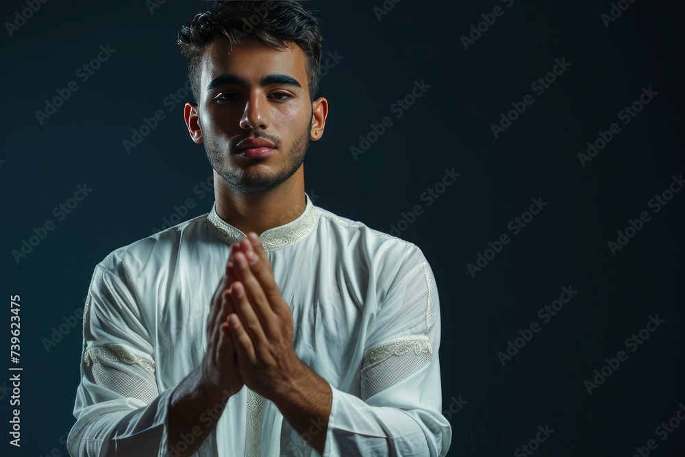 Muslim young man praying open her arm. one color background, copy space ...