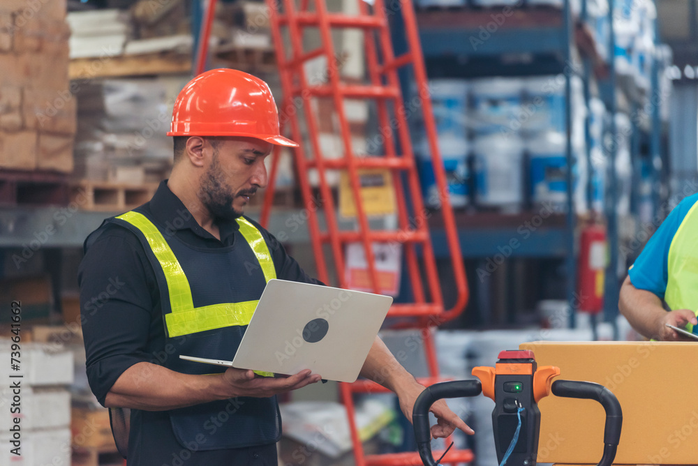 Warehouse worker teamwork diversity men using laptop computer logistics ...