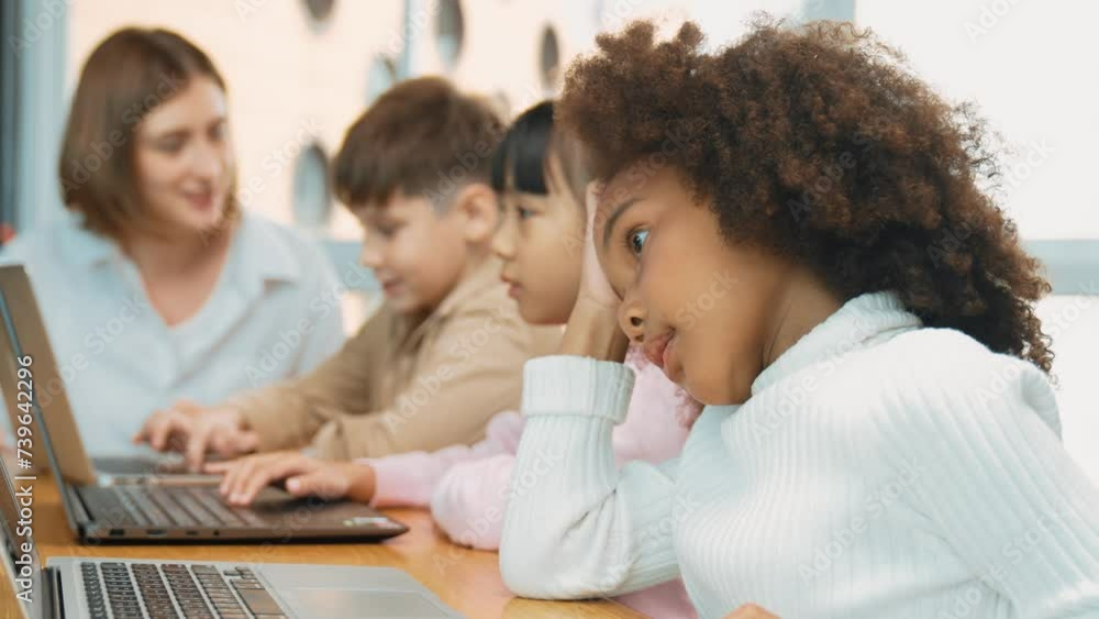 African girl play laptop with diverse friend learning prompt at STEM technology class ...