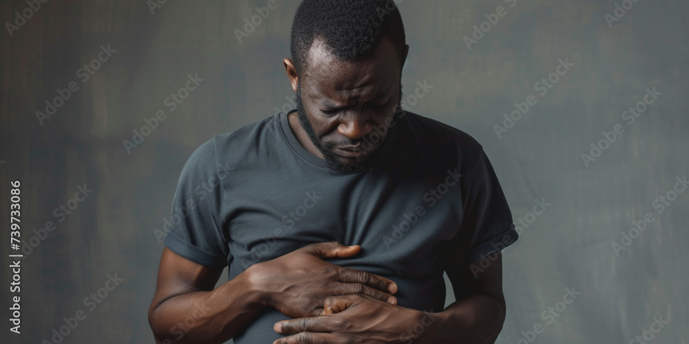 African-American man holds stomach painful suffering from stomachache ...